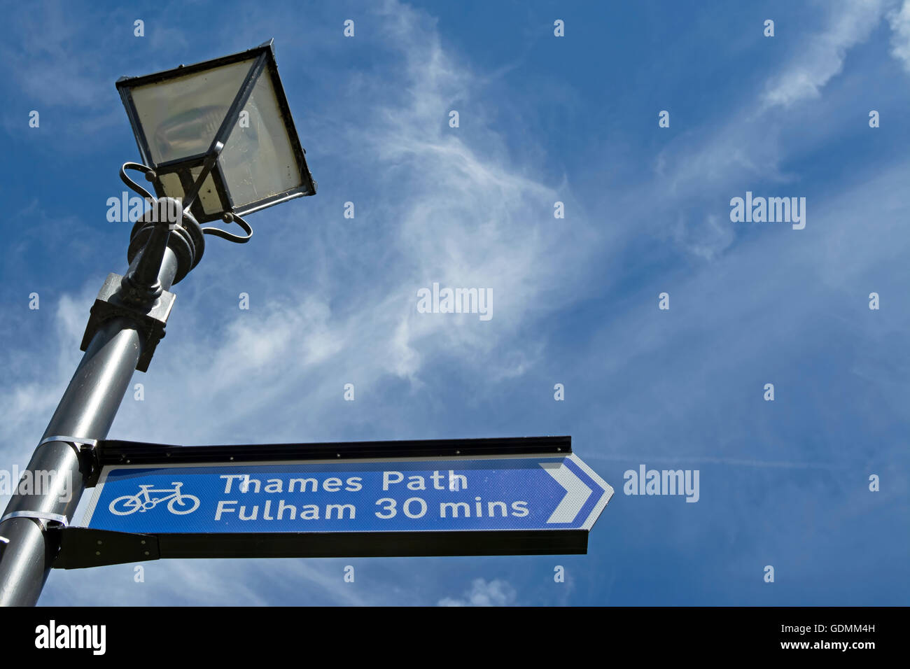 sign showing cycle route to thames path and fulham, with travel time ...
