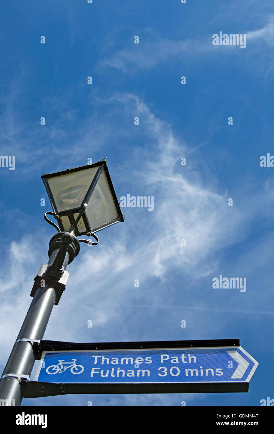 sign showing cycle route to thames path and fulham, with travel time ...