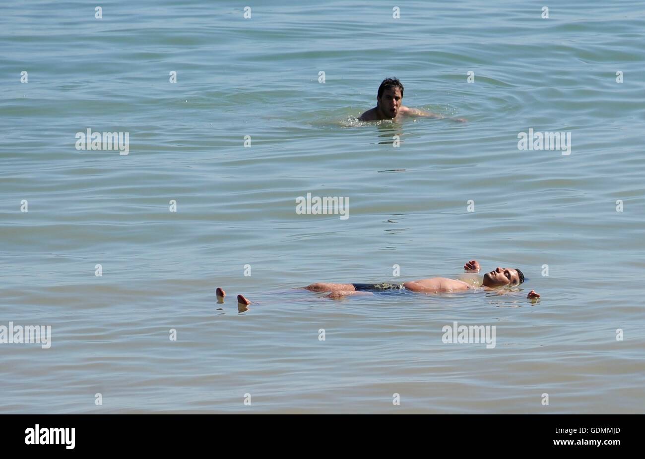 People enjoy the hot weather on Brighton beach, as a mini heatwave ...