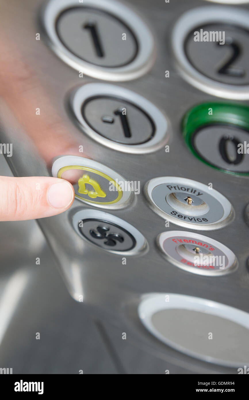 Forefinger pressing the alarm button in the elevator Stock Photo - Alamy