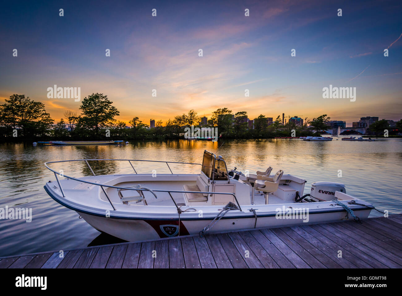 Boat and dock at sunset at the Charles River Esplanade, in Boston ...