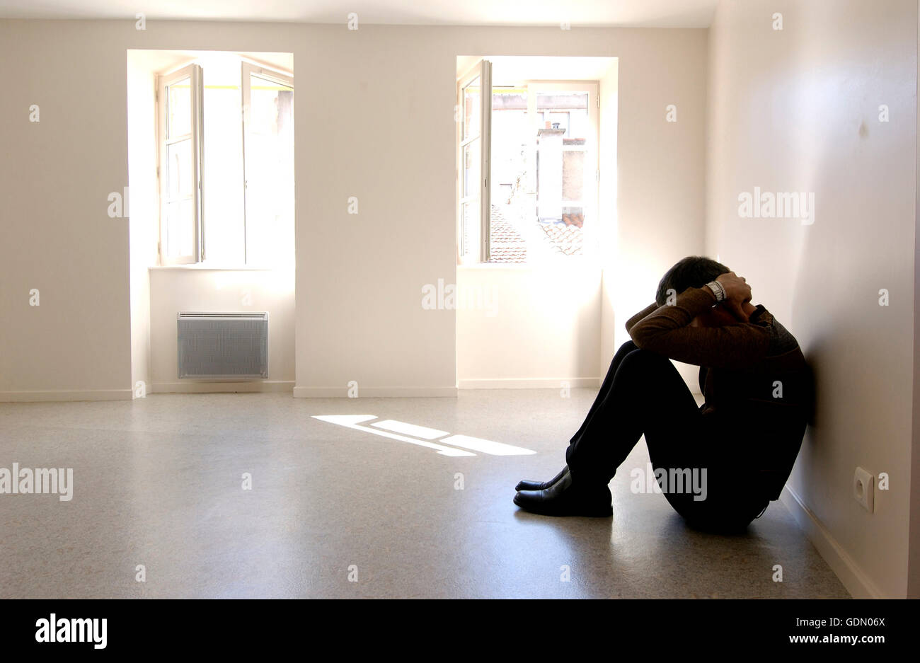 Man isolated in an apartment Stock Photo - Alamy