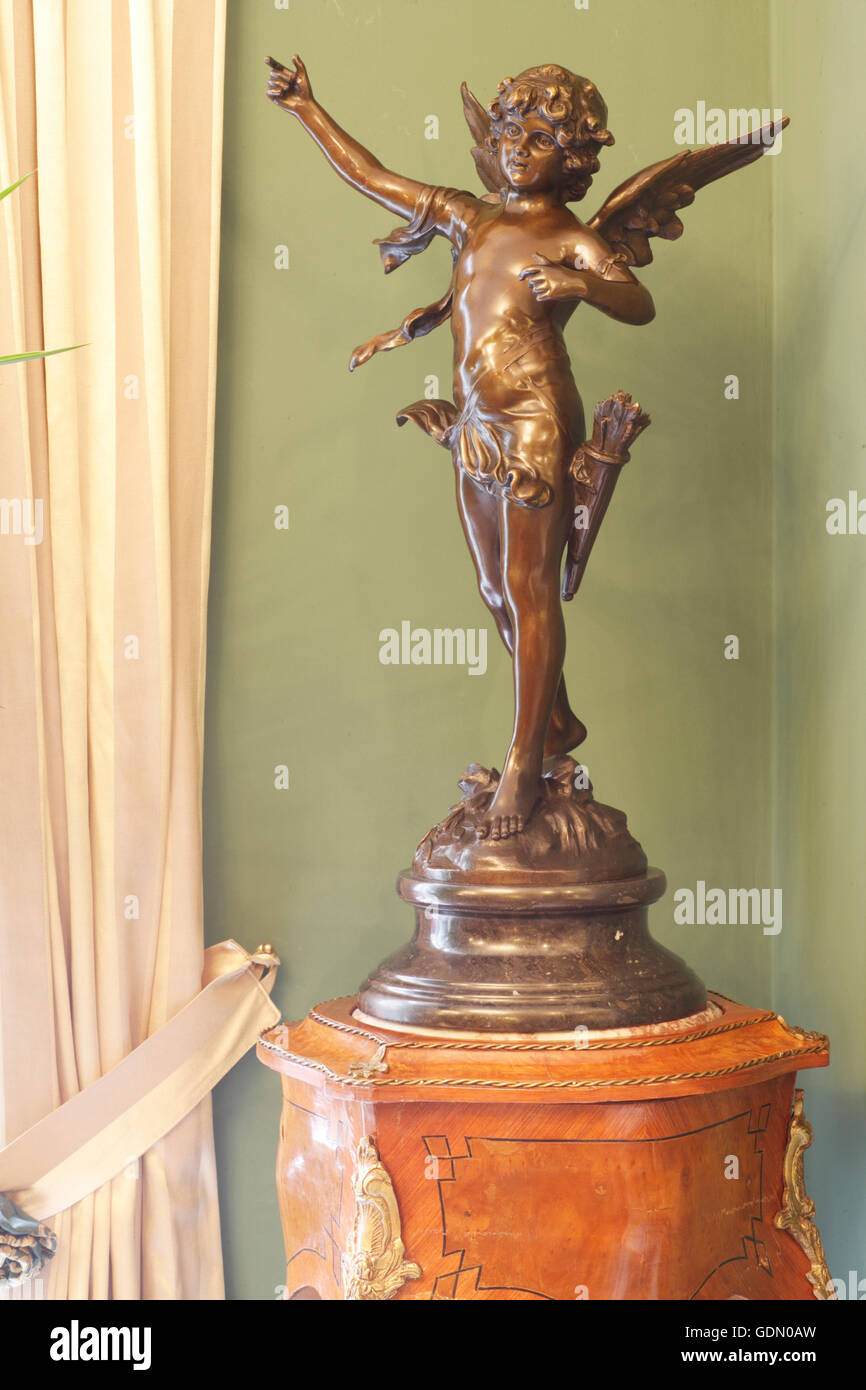 Decorative antique statue of Cupid Stock Photo - Alamy