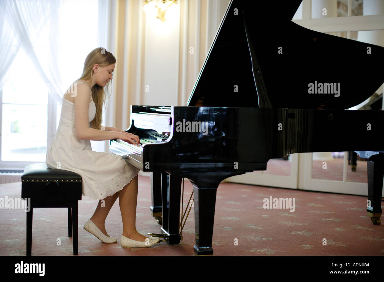 Woman Playing Grand Piano