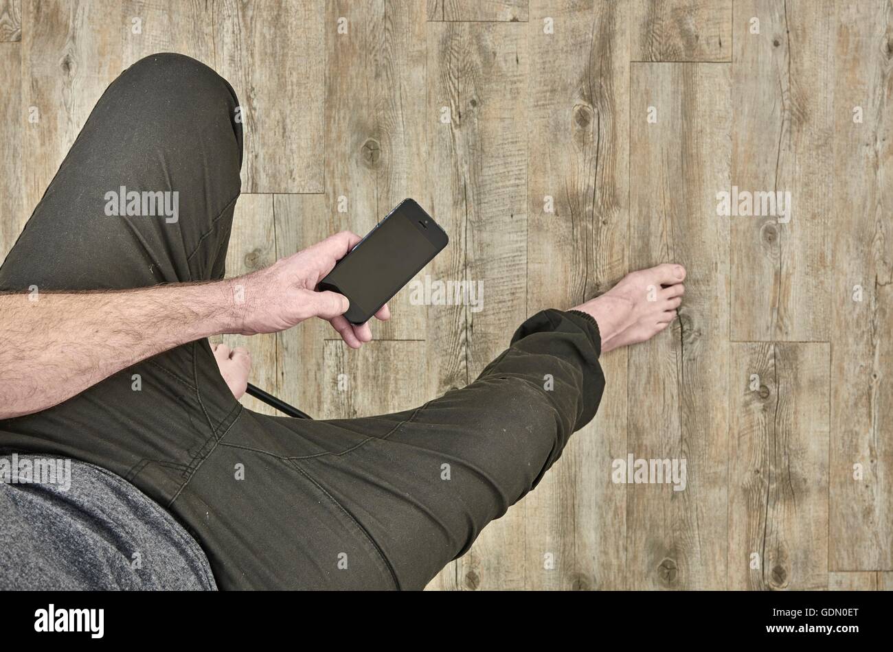A studio photo of a person sitting on a stool Stock Photo - Alamy