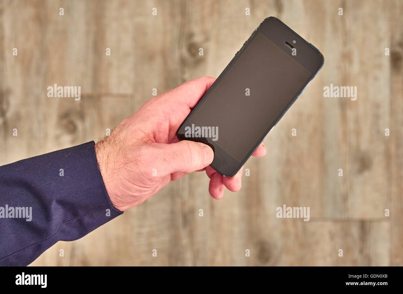 A studio photo of a mobile phone in hand Stock Photo - Alamy