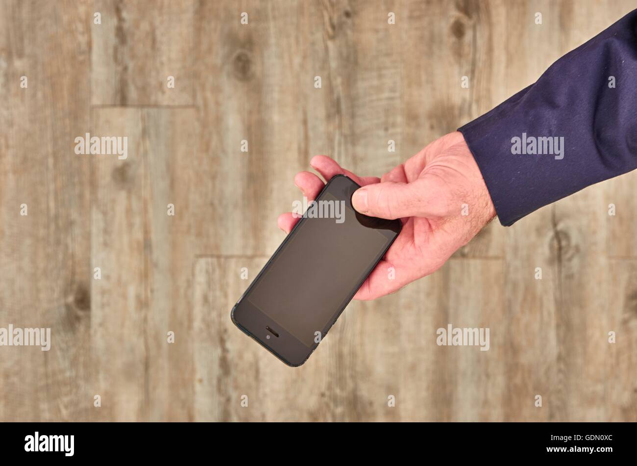 A studio photo of a mobile phone in hand Stock Photo - Alamy
