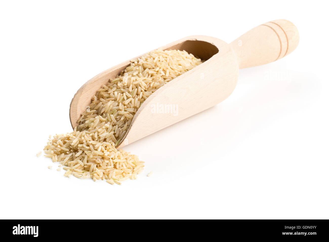 Natural brown uncooked rice in wooden scoop over white background Stock ...