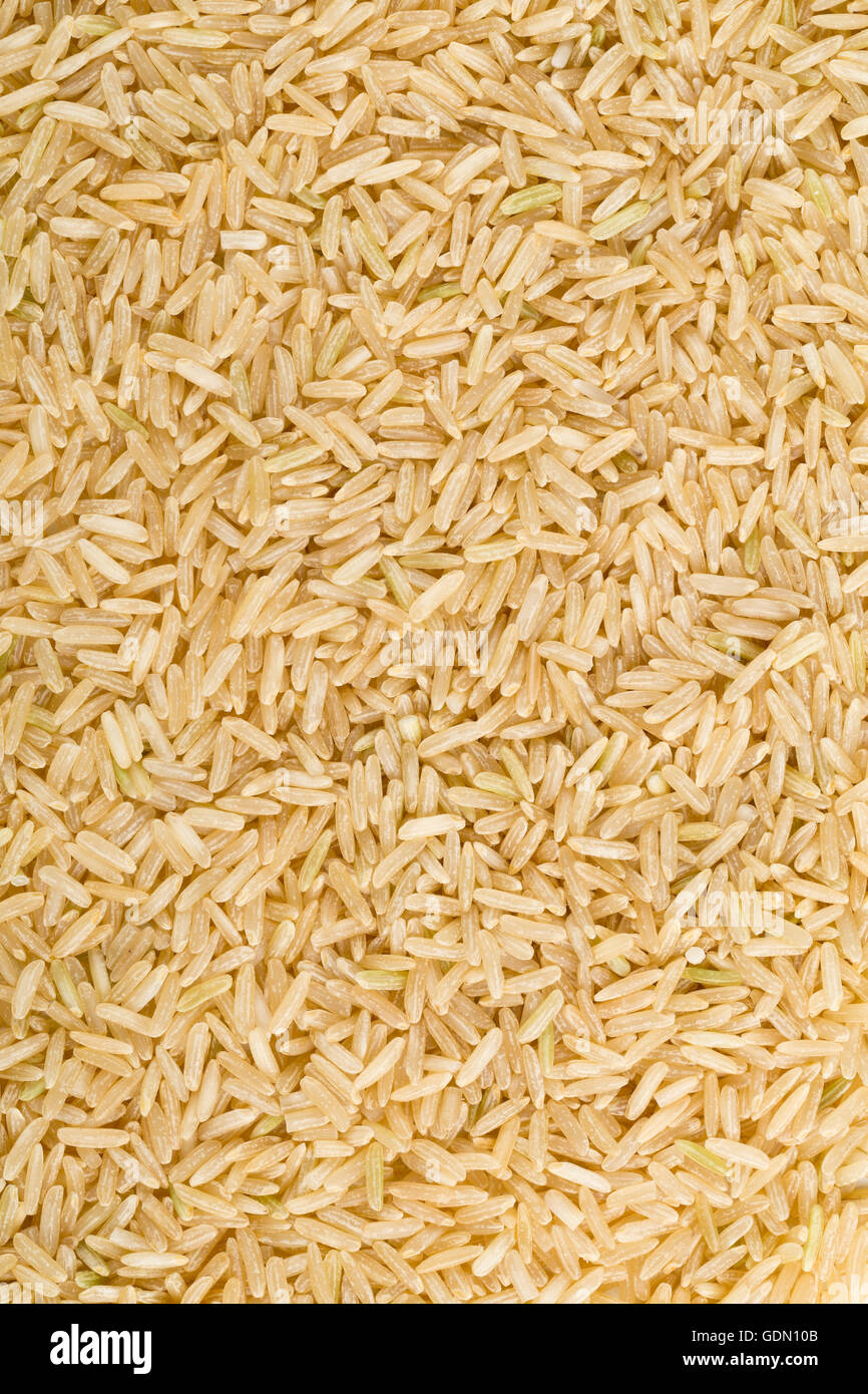 Natural brown uncooked rice frame filling background Stock Photo - Alamy