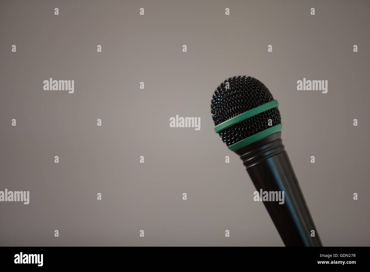 Metal wire mesh black microphone on a gray background. Hand mic Stock ...