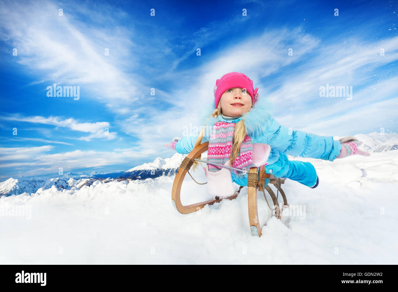 Little girls slide on sledge winter sunny day Stock Photo - Alamy