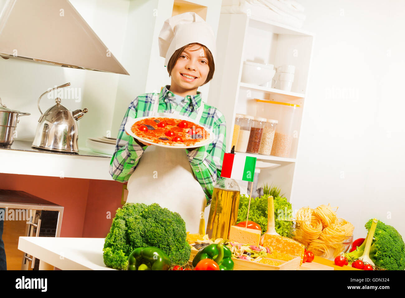 Young boy demonstrates traditional Italian cuisine Stock Photo - Alamy