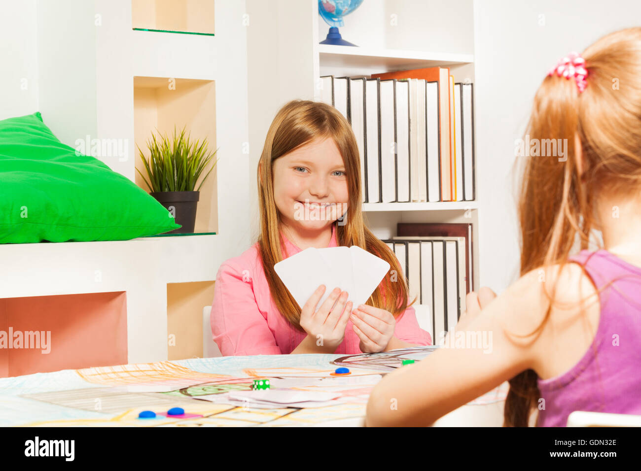 Girl playing cards hi-res stock photography and images - Alamy
