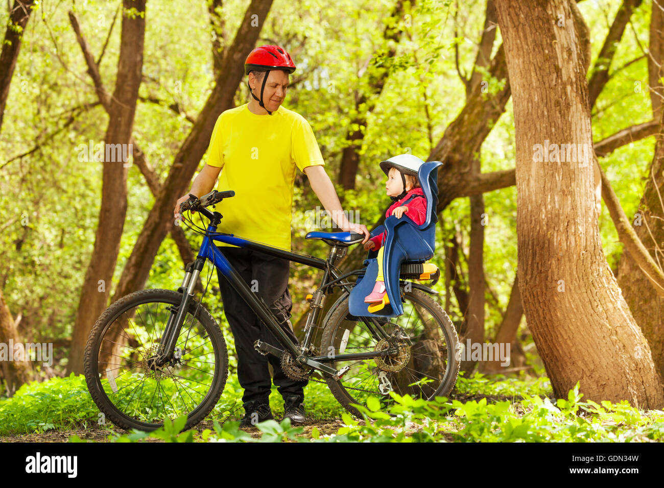 Active father and his little daughter riding bike Stock Photo - Alamy