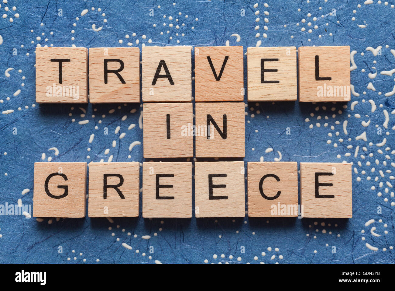 Wooden letters spelling TRAVEL IN GREECE on blue background Stock Photo ...