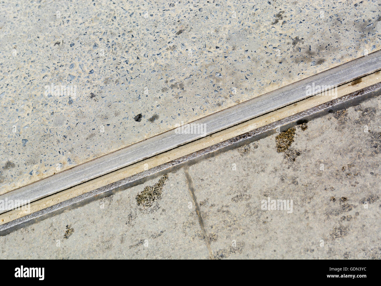 old tram rails in the concrete road gray with spots Stock Photo - Alamy