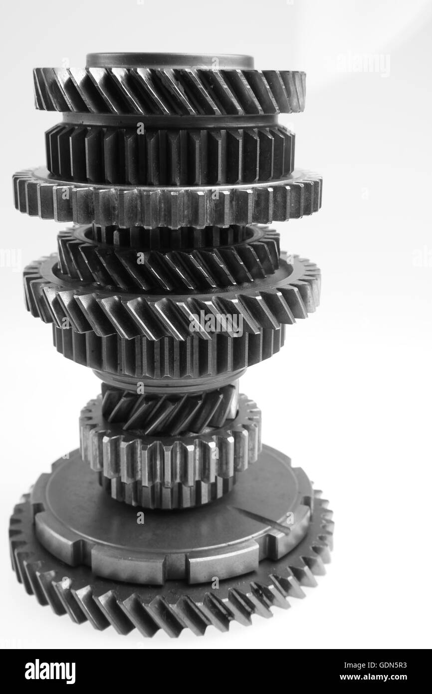 Steel cogs together on plain background Stock Photo - Alamy