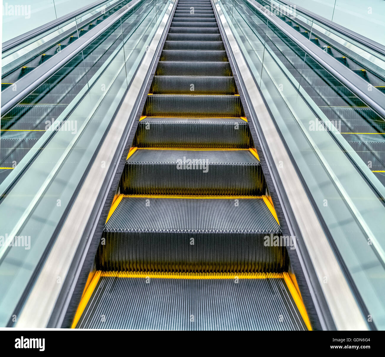 Modern looking glass & steel escalator building interior / urban image ...
