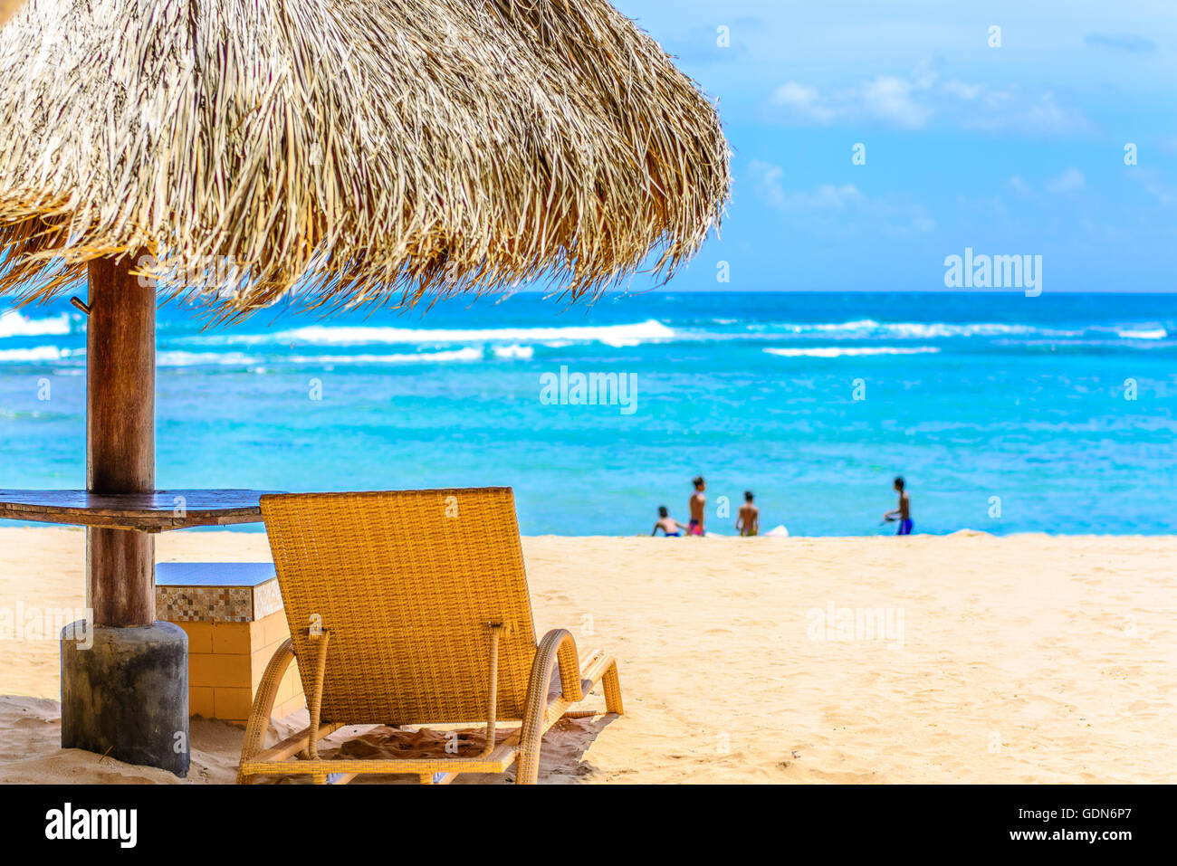 A beautiful beach scene with sunshade and chairs on a tropical paradise ...