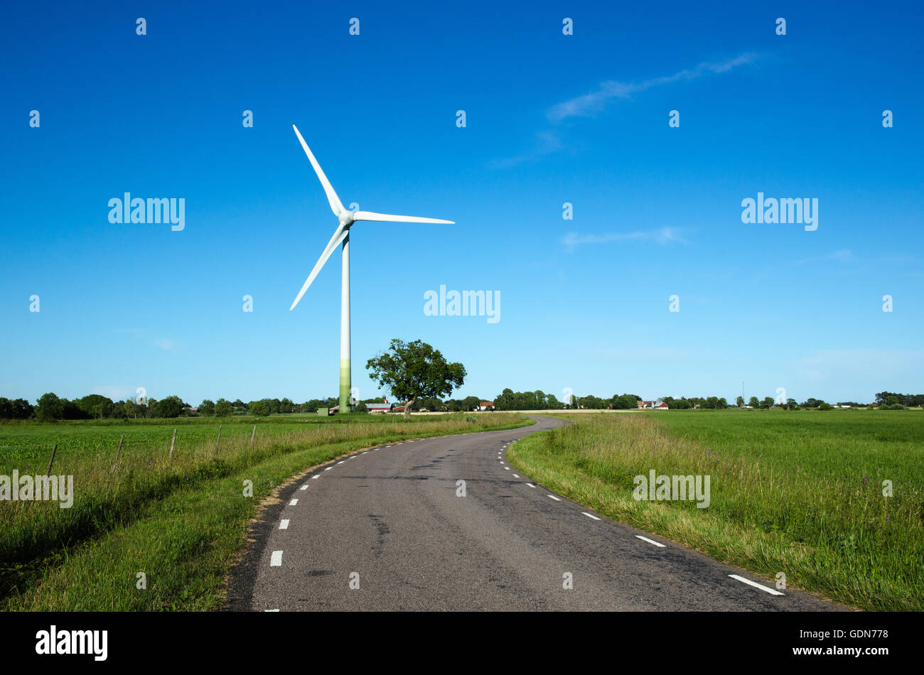 Windmill by a country road side in a green landscape Stock Photo - Alamy