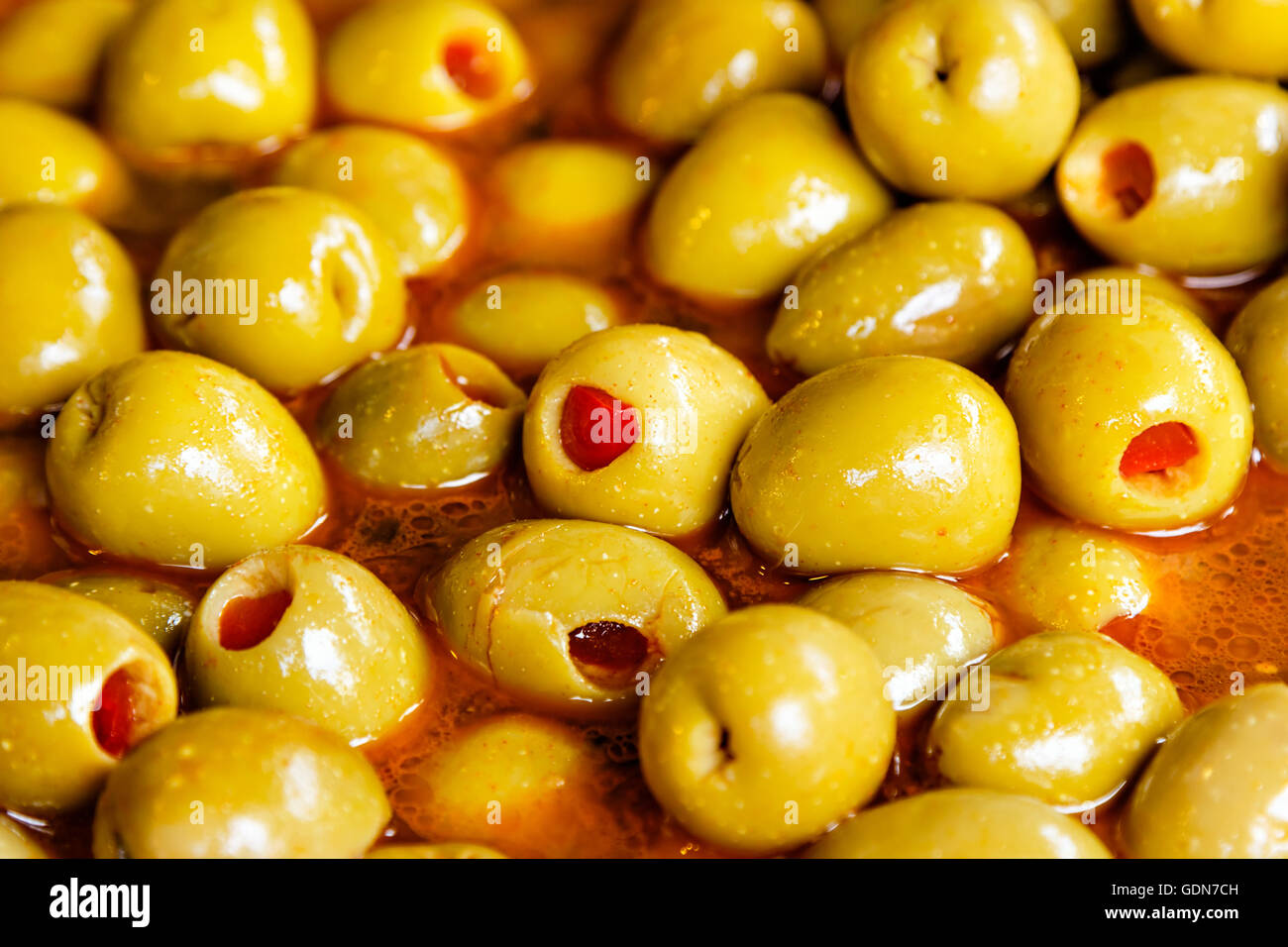 Red sweet pepper stuffed olives on a traditional craftsman market ...