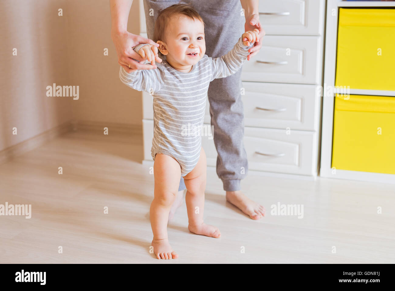baby steps with the help of his mother Stock Photo - Alamy