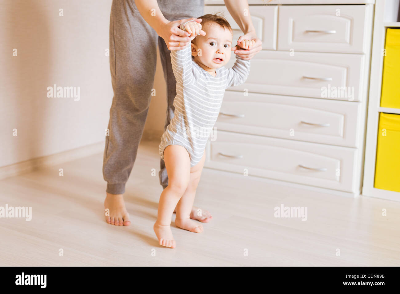 baby steps with the help of his mother Stock Photo - Alamy