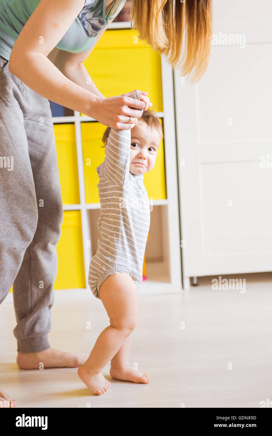 baby steps with the help of his mother Stock Photo - Alamy