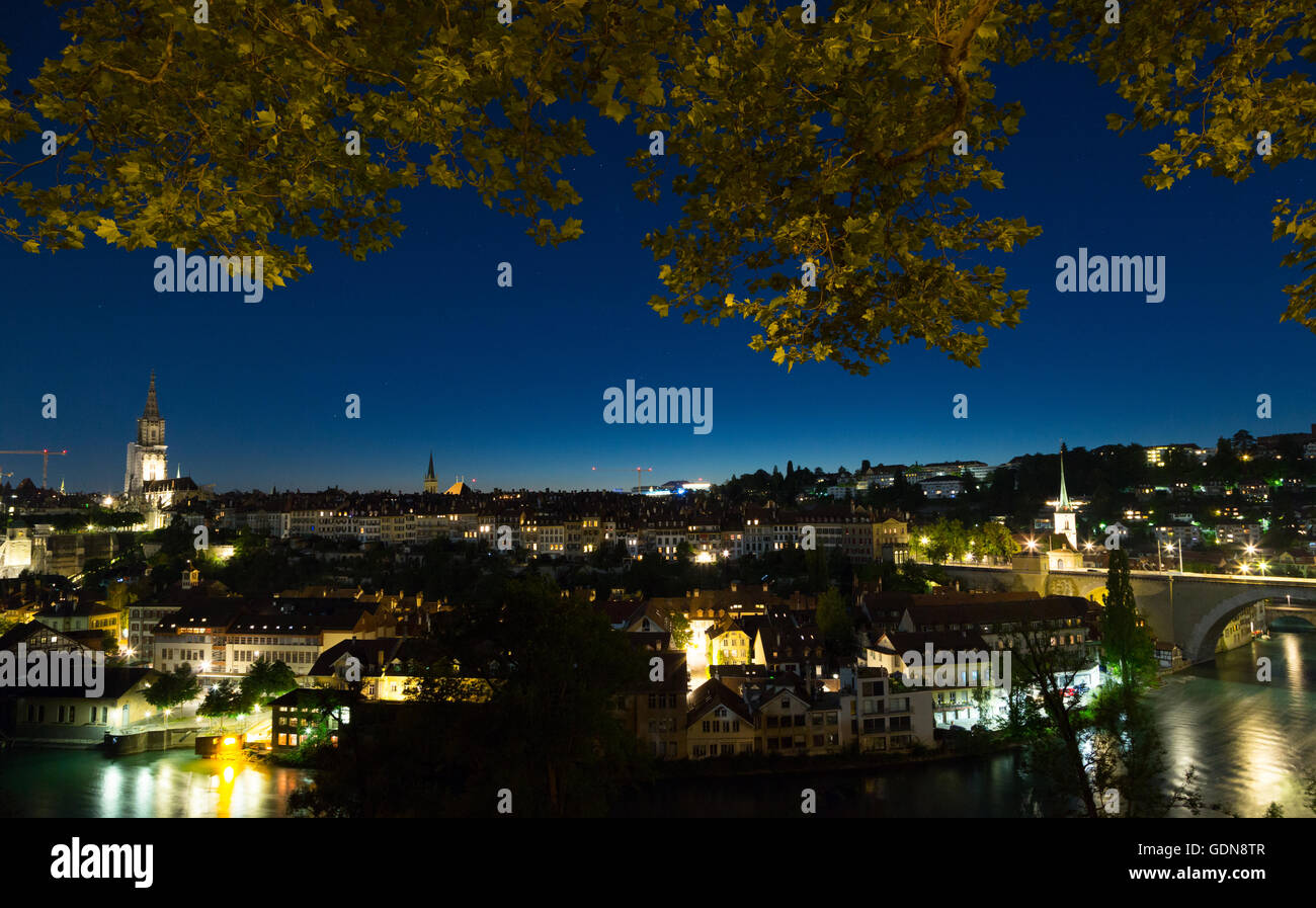 A photograph of the old city of Bern at night, with the River Aare ...