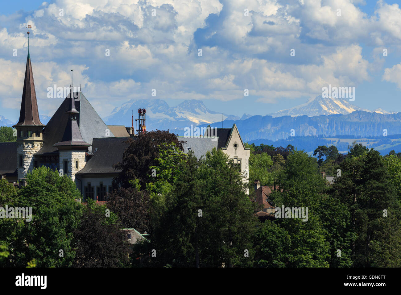 A photograph of the Bern Historical Museum and the Swiss Alps as seen ...