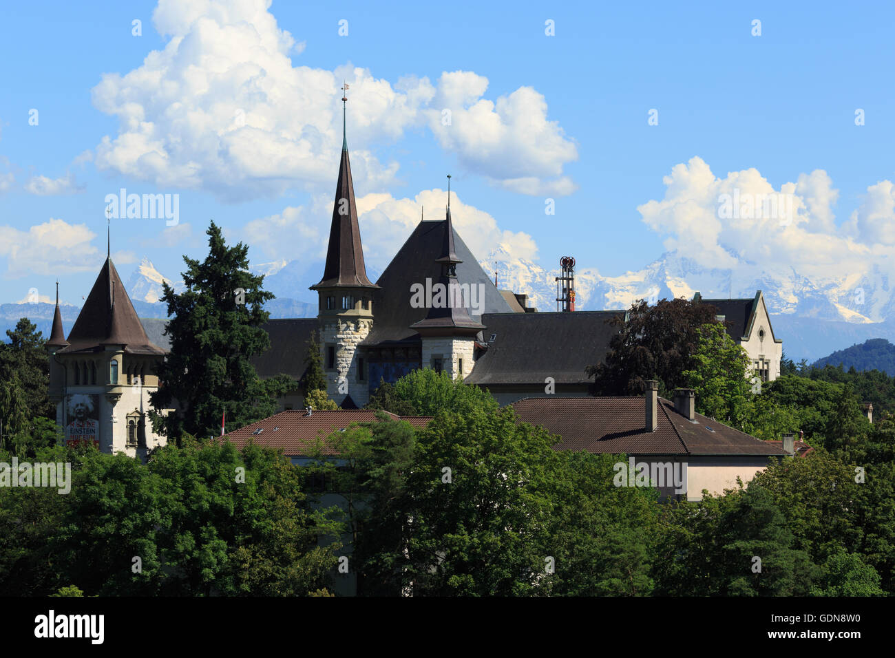 A photograph of the Bern Historical Museum and the Swiss Alps as seen ...