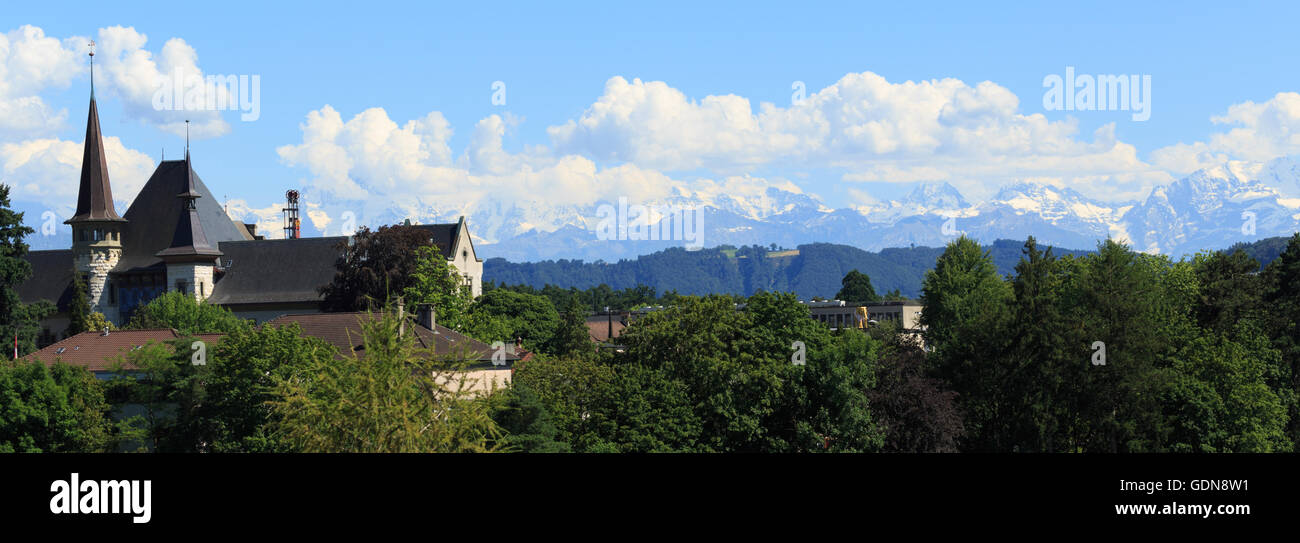 A photograph of the Bern Historical Museum and the Swiss Alps as seen ...