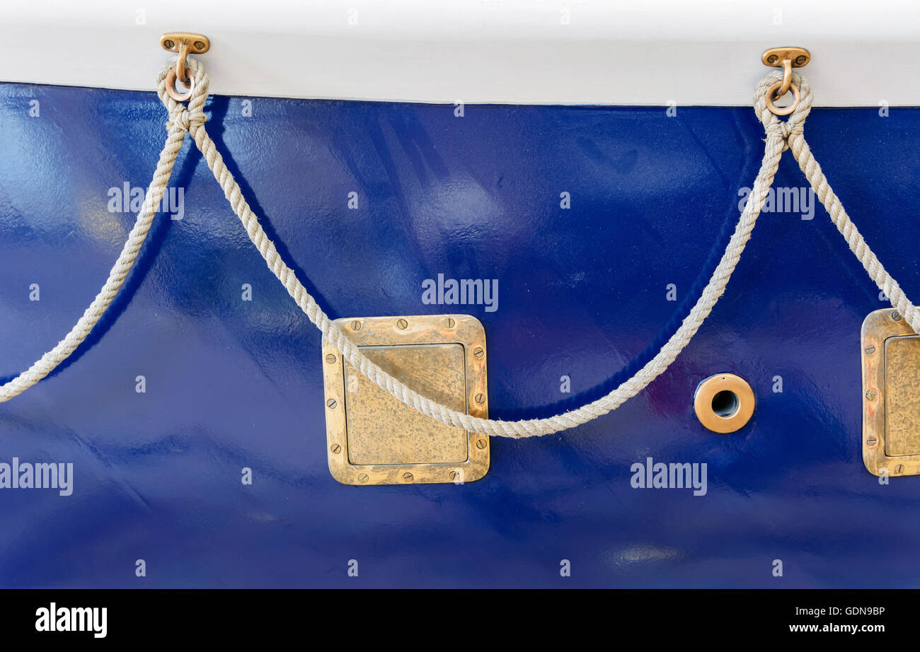 Blue aboard an old ship and hanging on the rope it in bronze eyelets ...