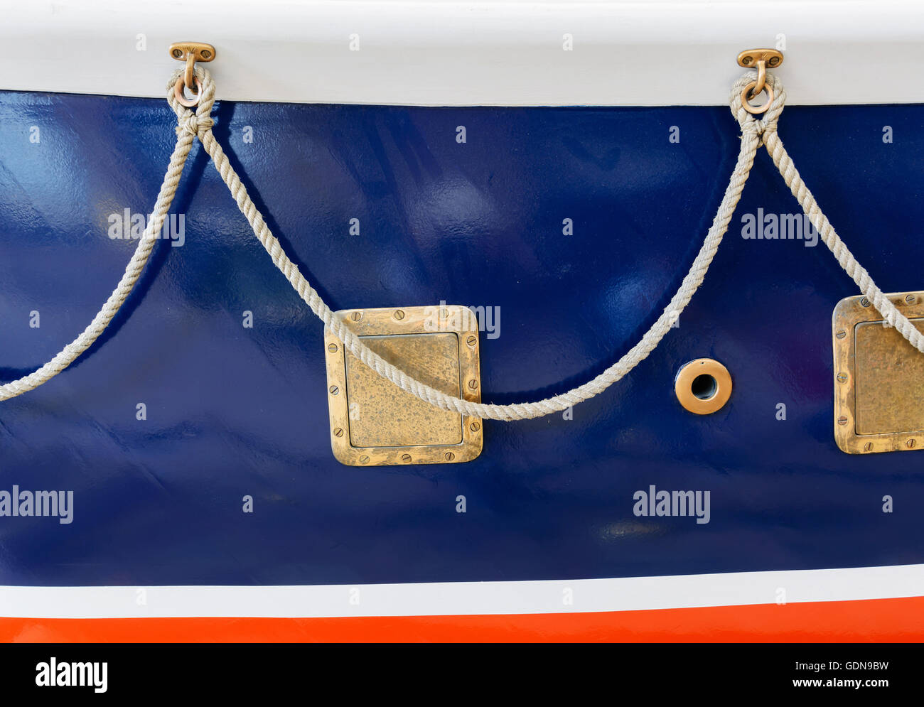Blue aboard an old ship and hanging on the rope it in bronze eyelets ...