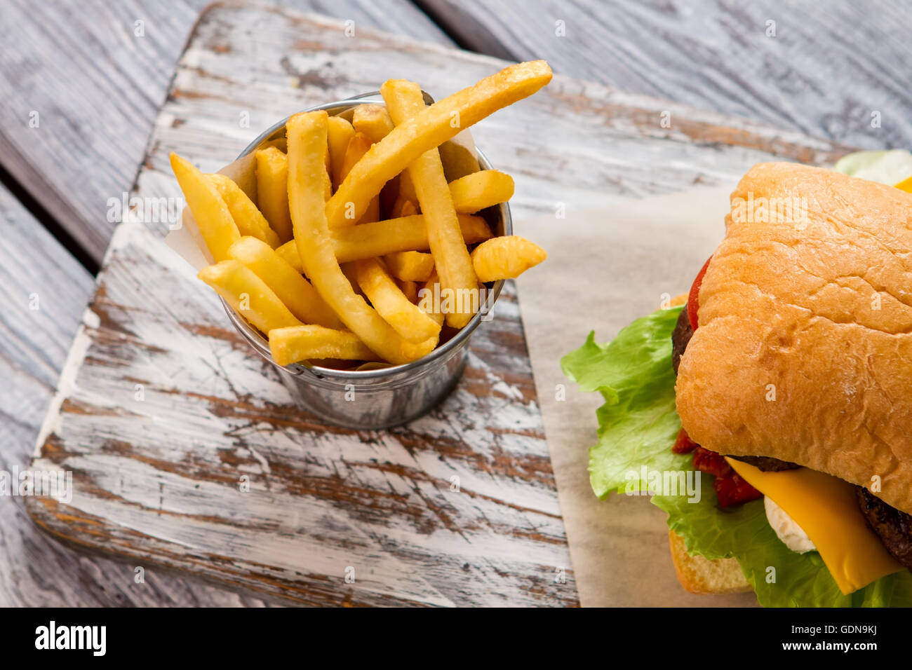 Hamburger and bucket with fries Stock Photo - Alamy