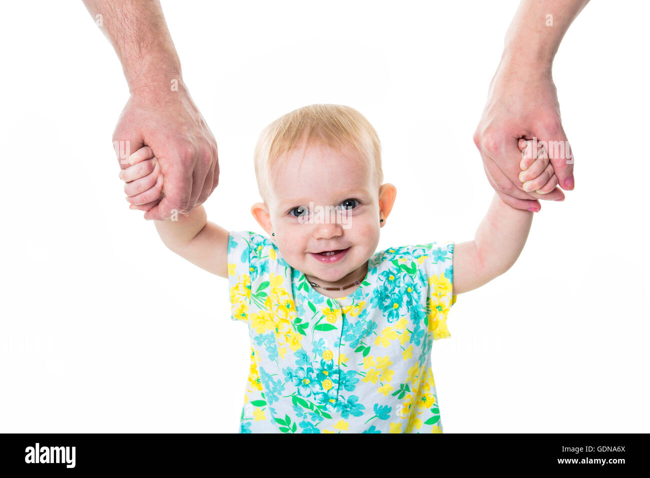 baby taking first steps with mother father help on white background ...