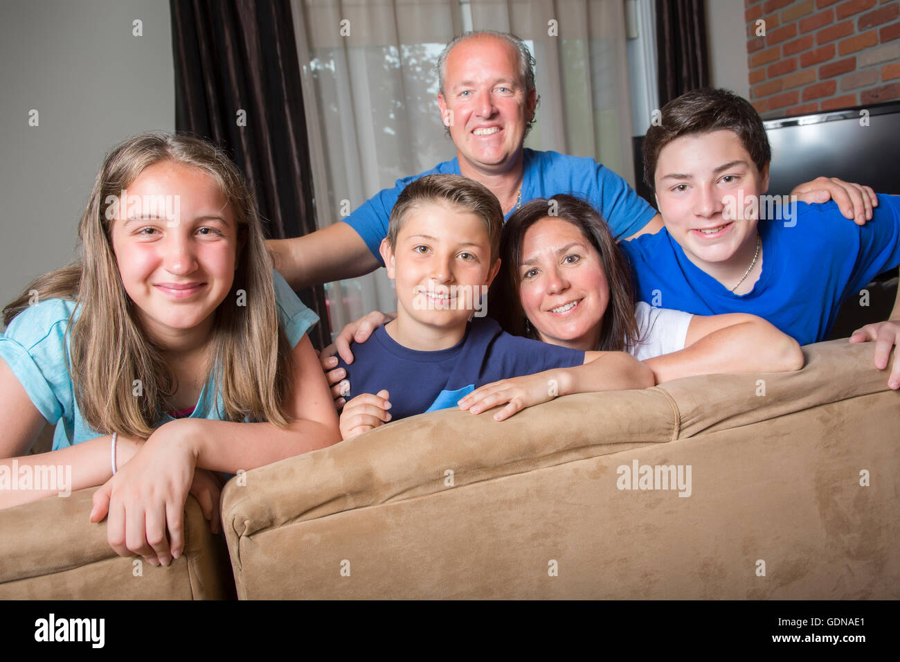 Family Relaxing Indoors Watching Television Together Stock Photo - Alamy