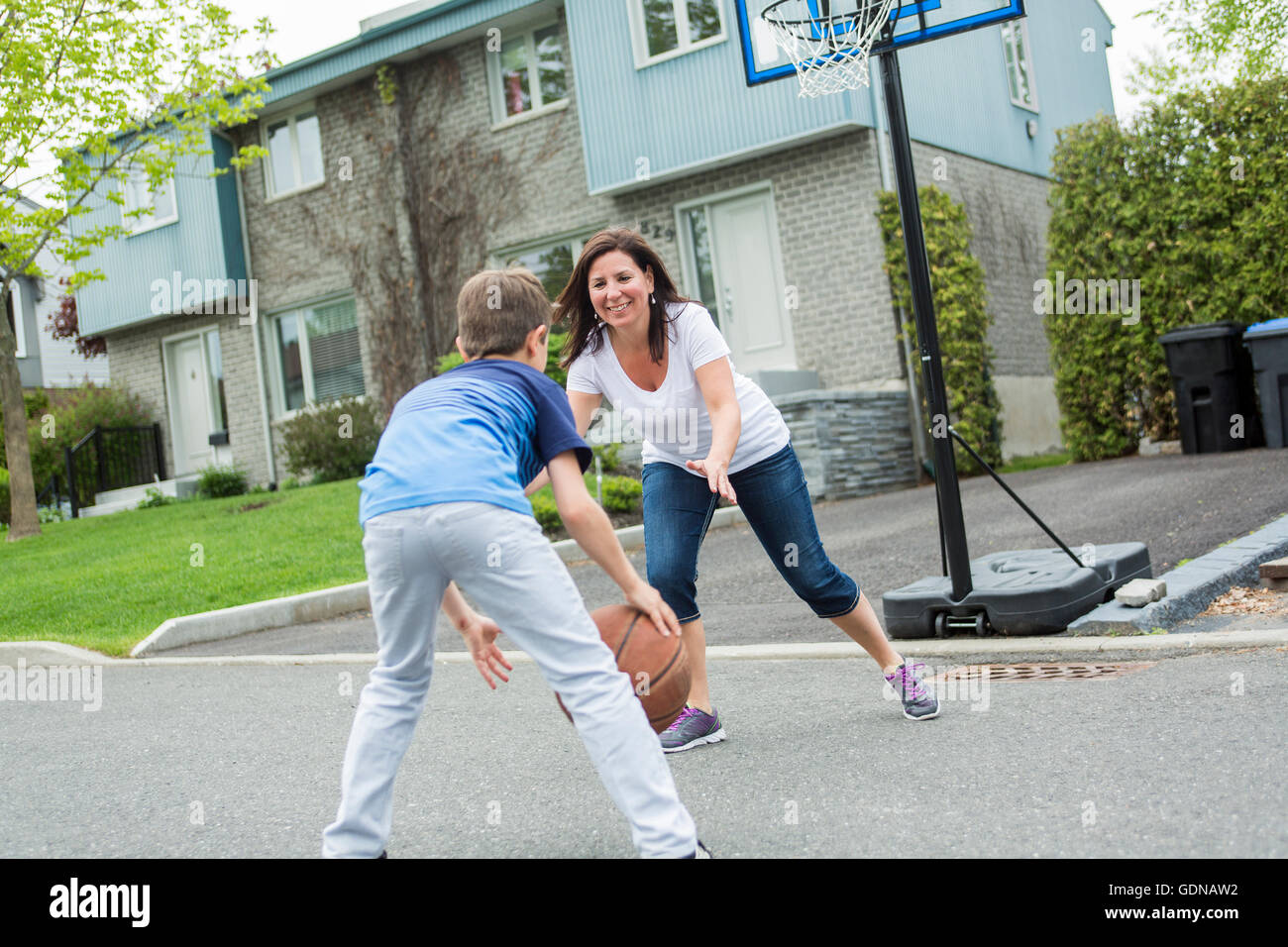 Happy family having fun outside with a basketball Stock Photo - Alamy