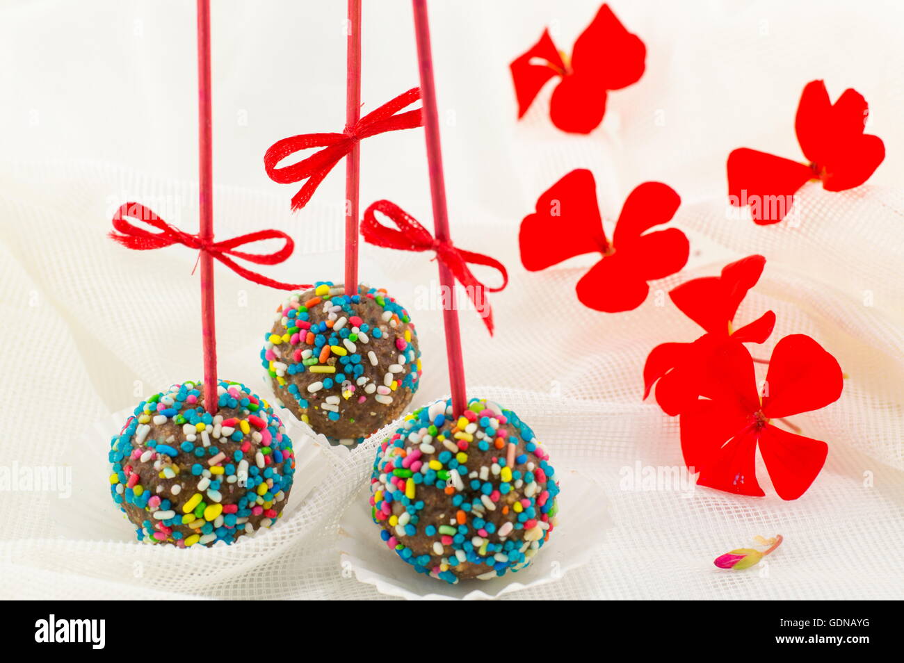Cake pops on a table covered with white silk fabric Stock Photo - Alamy