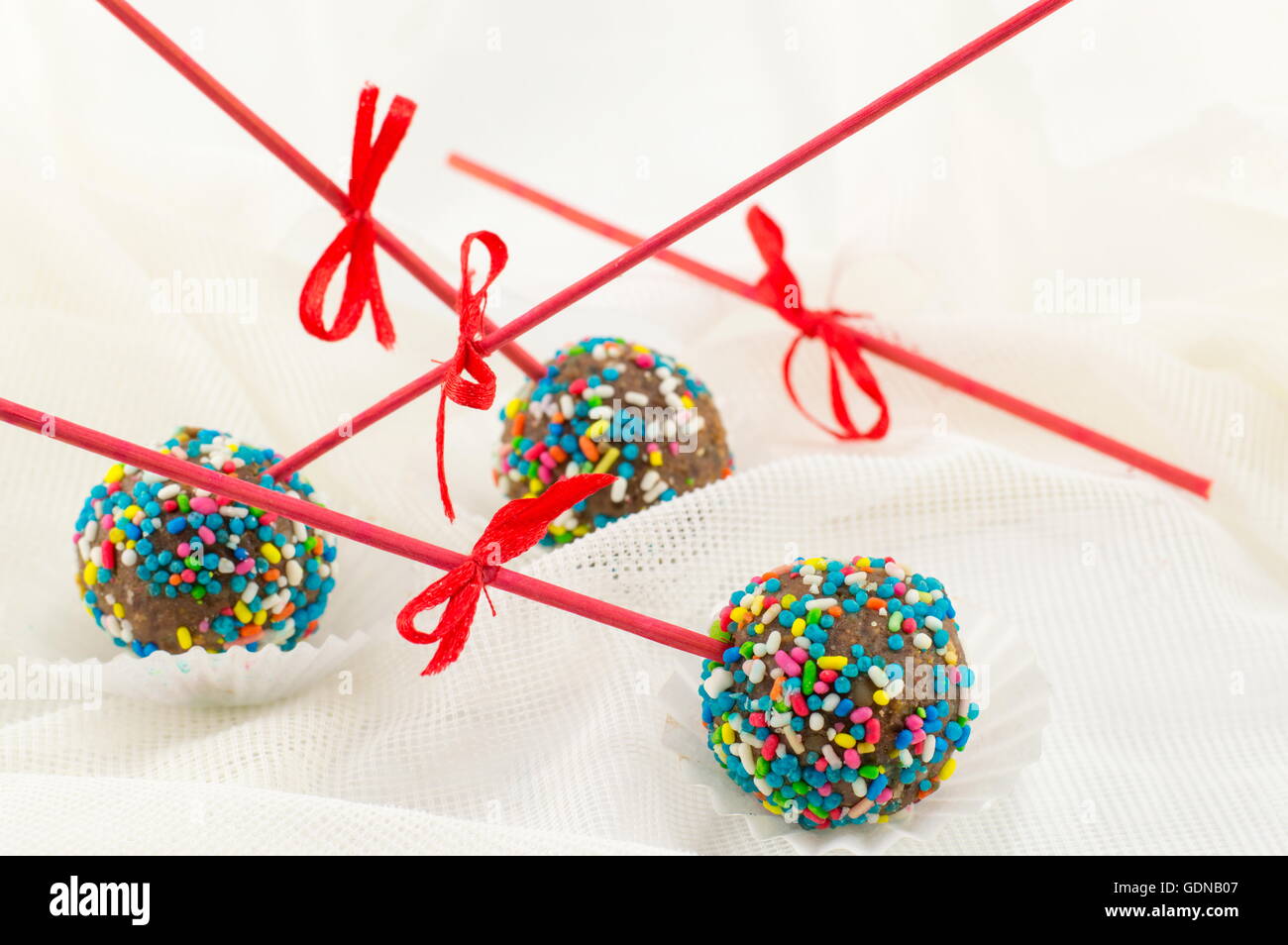 Cake pops on a table covered with white silk fabric Stock Photo - Alamy
