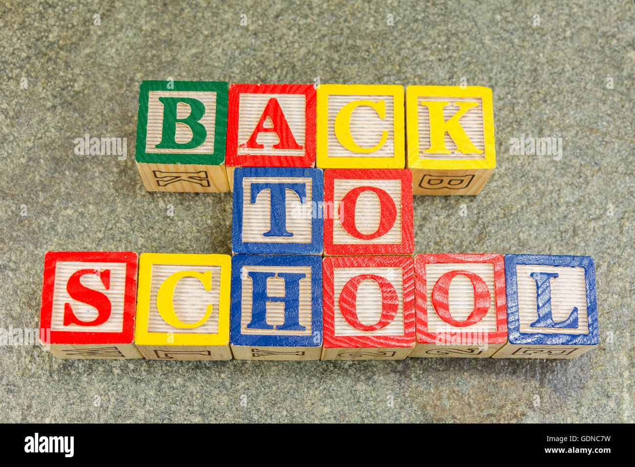 Back to school written with wooden letters on stone table Stock Photo ...