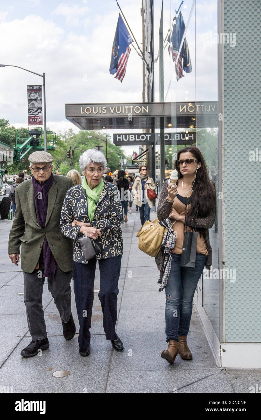 elegantly casual elder couple look askance as fortyish woman in ...