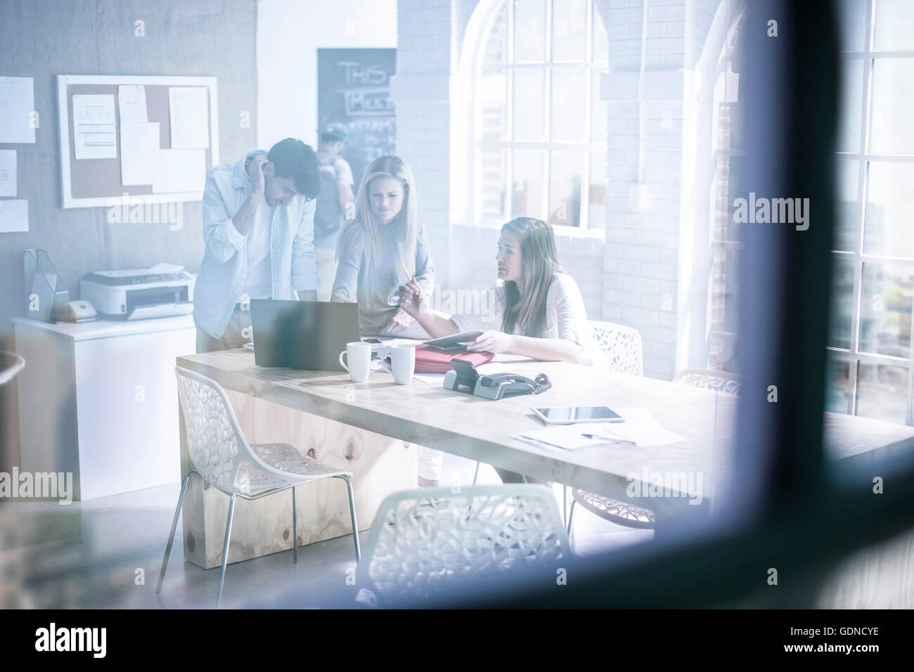 Design team meeting at boardroom table in design studio Stock Photo - Alamy