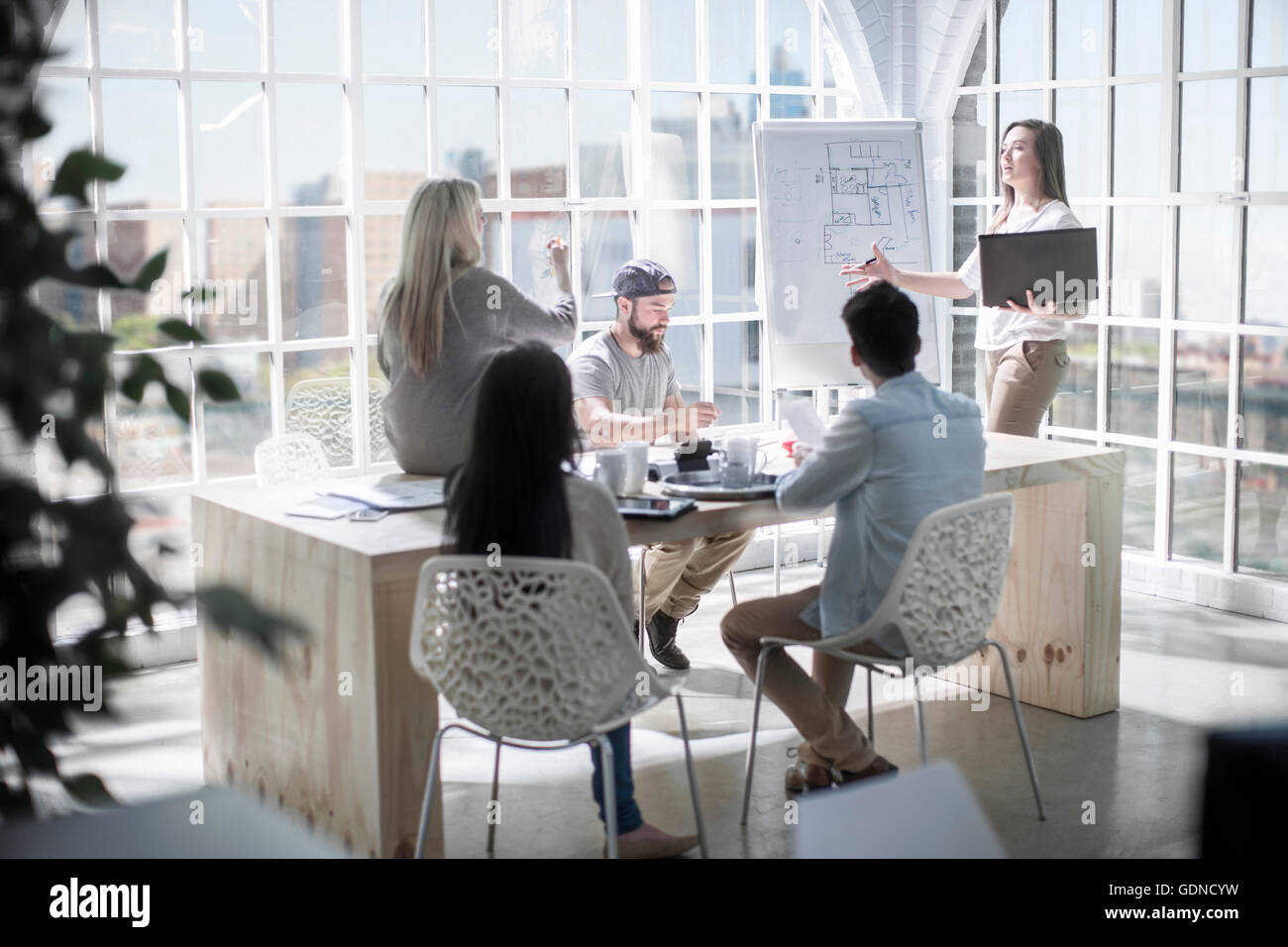 Design team presentation discussing blueprints in design studio Stock ...