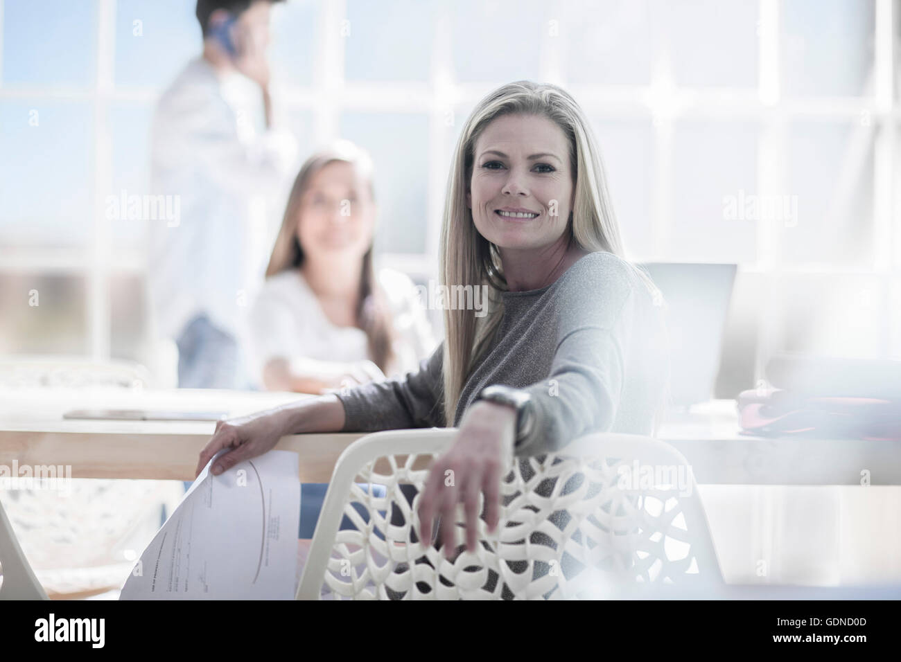 Portrait of female designer holding blueprint in design studio Stock ...
