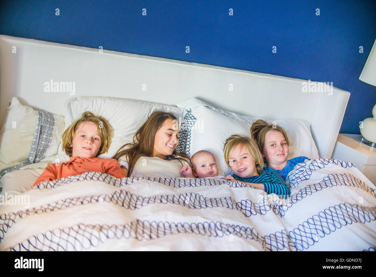 Brothers and sister side by side in bed together Stock Photo - Alamy