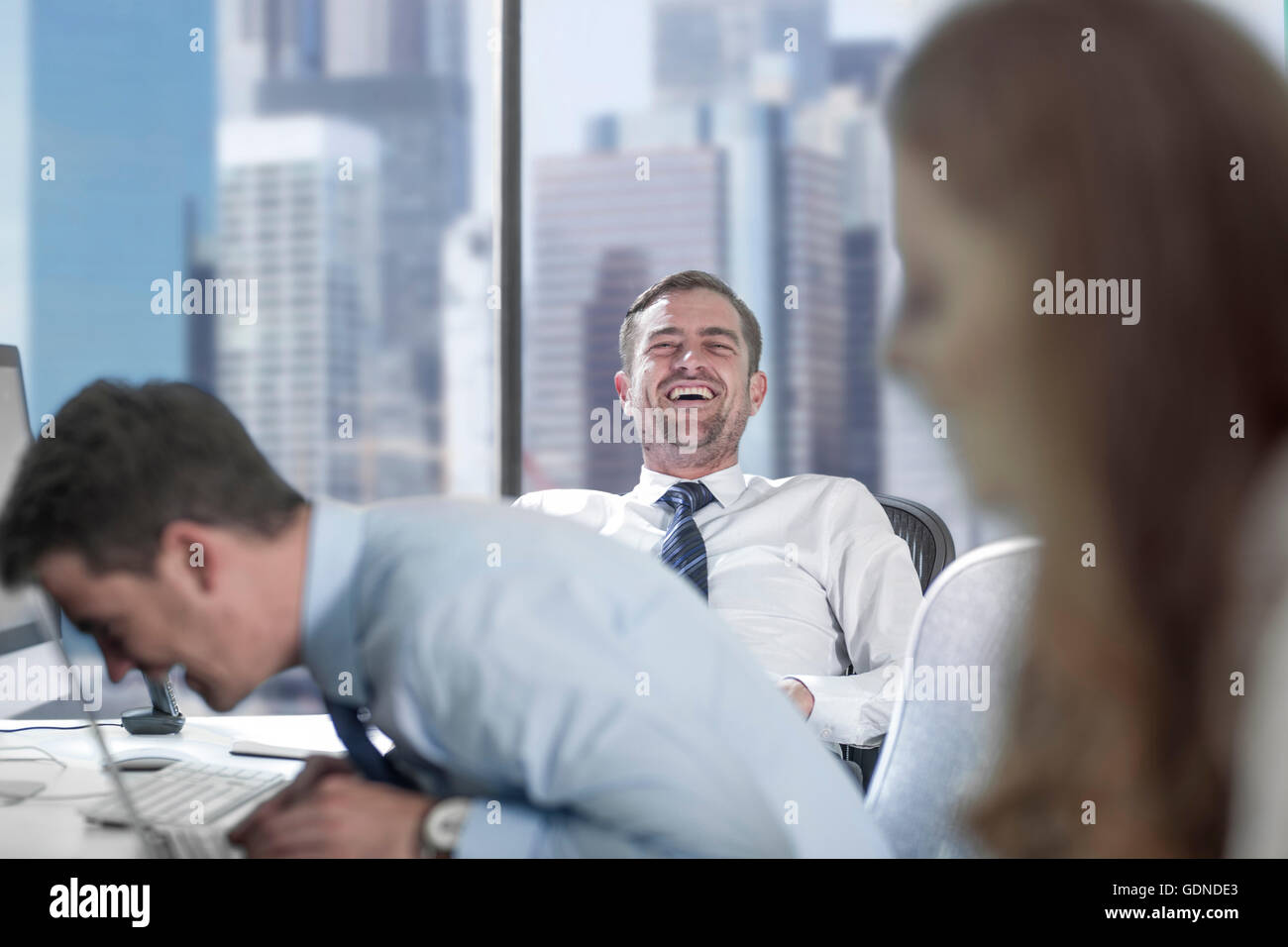 Businessmen laughing in office Stock Photo - Alamy