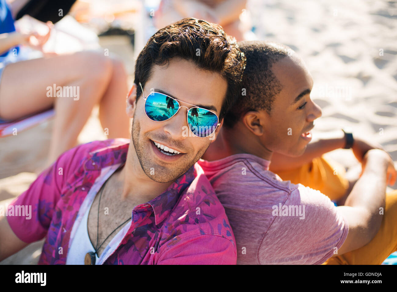 Two men sitting back back hi-res stock photography and images - Alamy