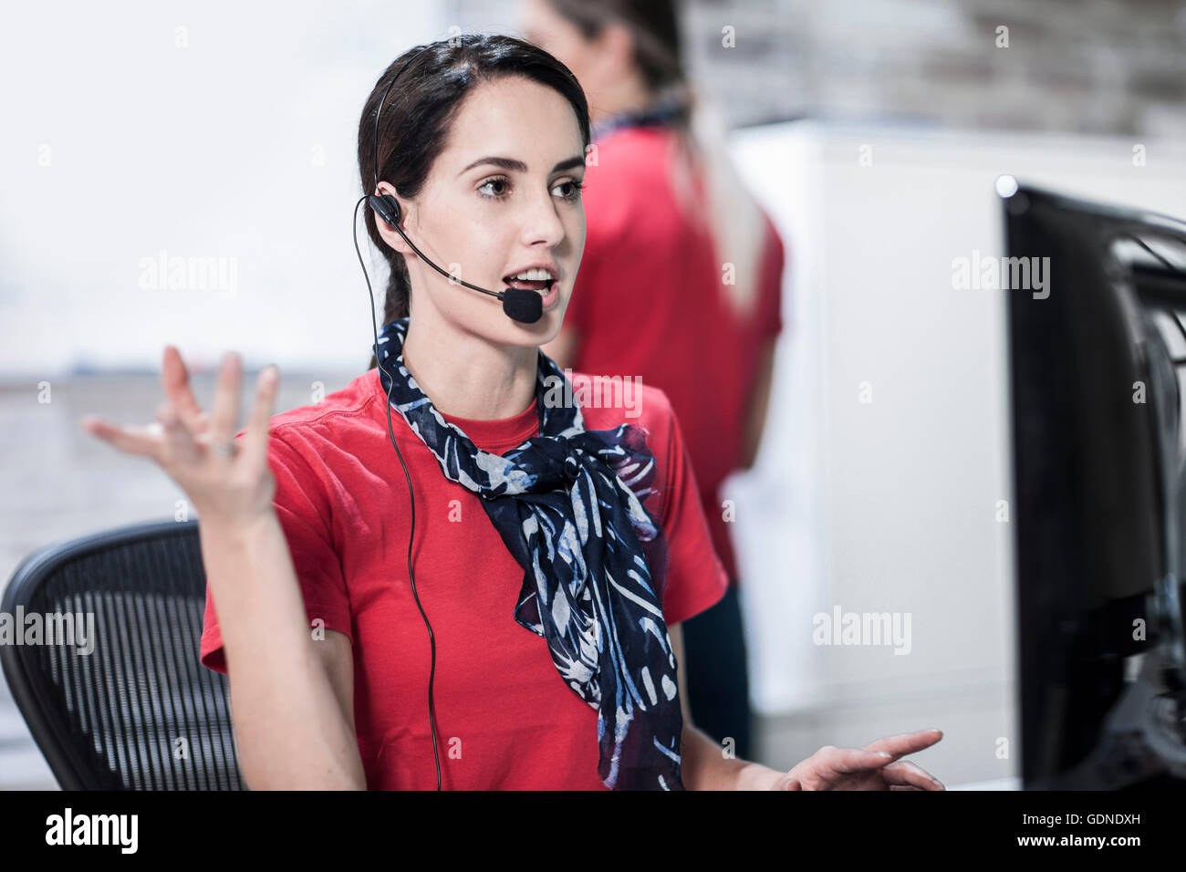 Female telephonist explaining in call centre Stock Photo - Alamy