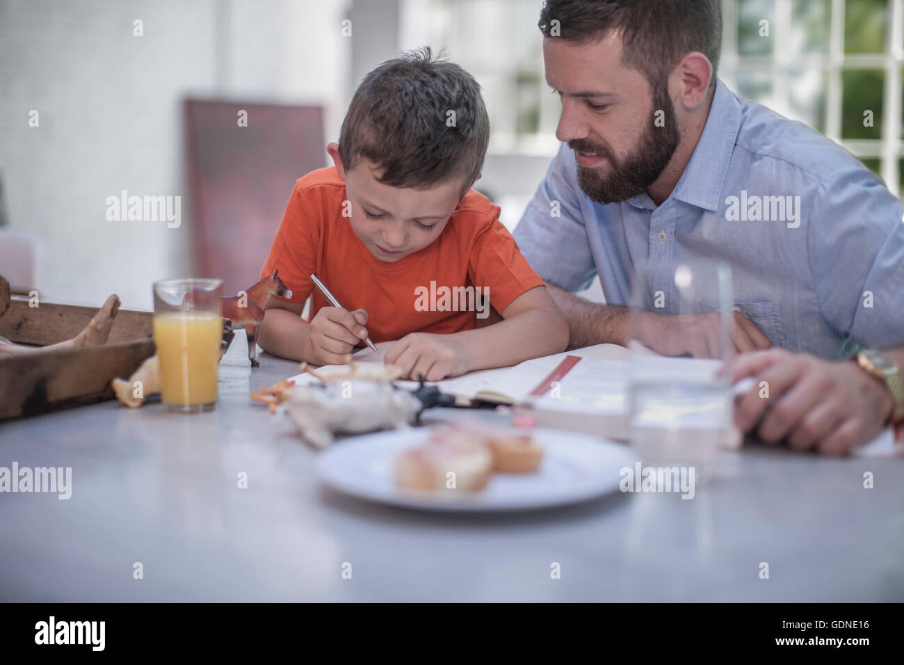 Father teaching son to write Stock Photo - Alamy